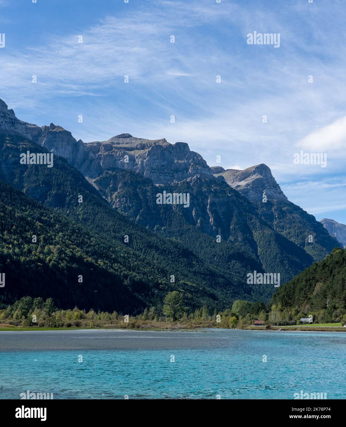man-made aqua blue water reservoir to feed a mountain hydro power ...