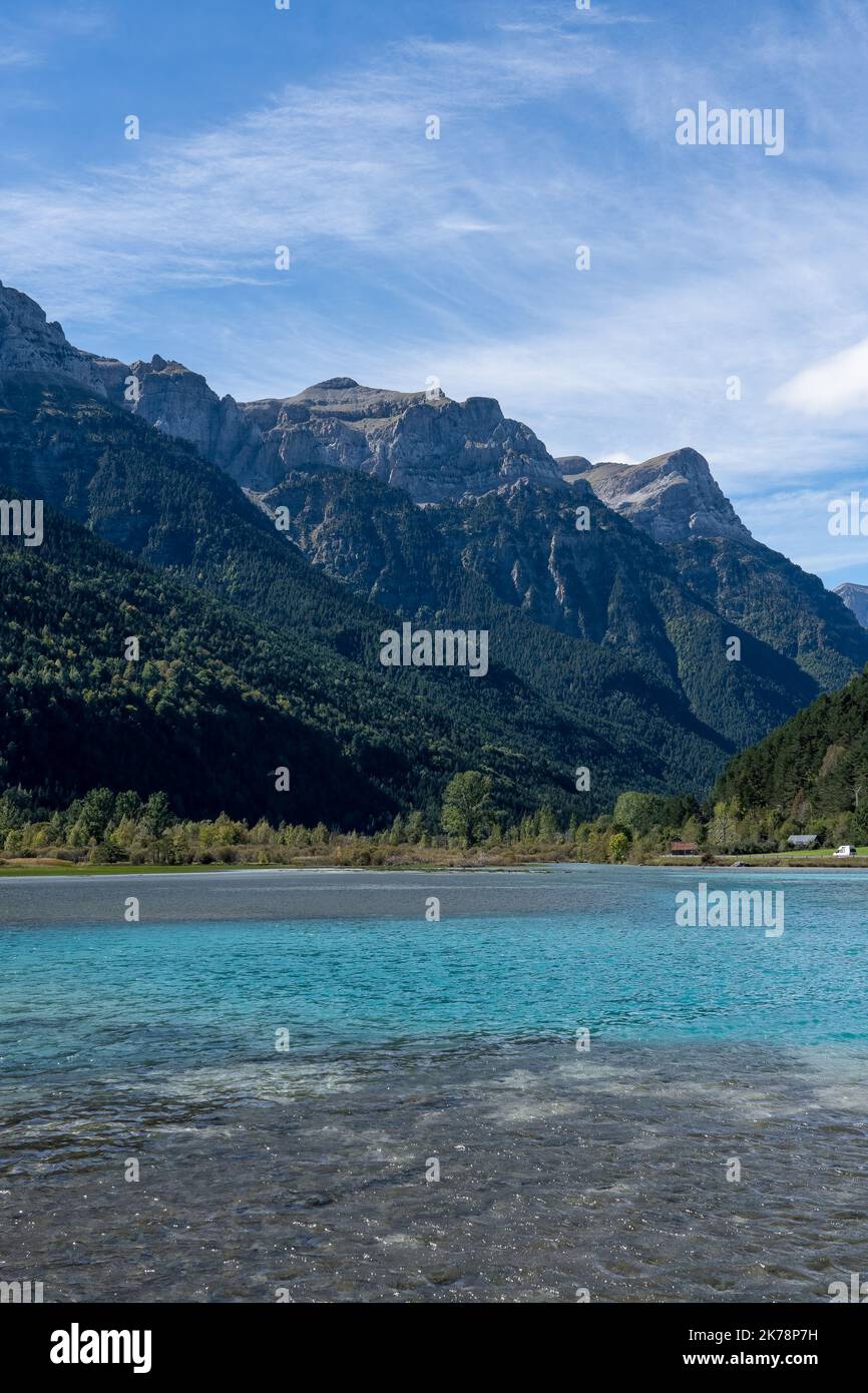 man-made aqua blue water reservoir to feed a mountain hydro power ...