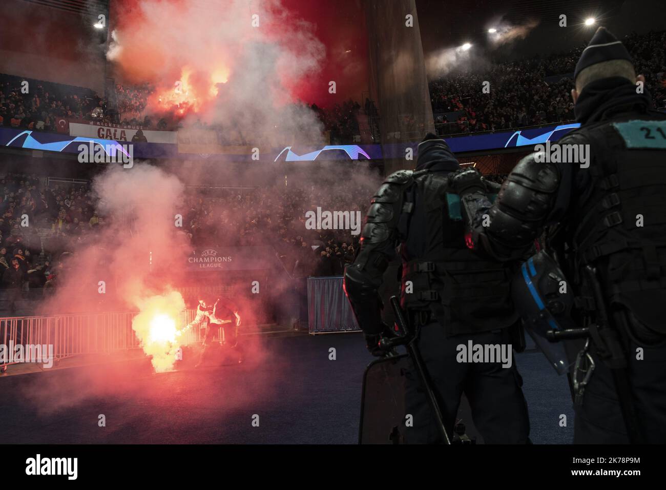 Police watch over the crowd as flares are thrown onto the pitch Stock ...