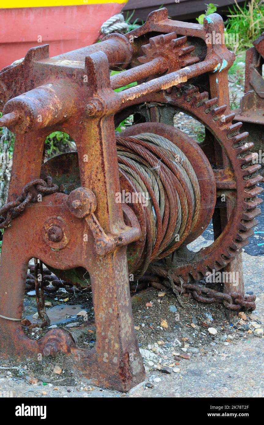 Rusty maritime winch on harbour wall Stock Photo - Alamy