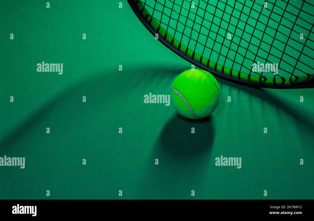 Tennis racket and yellow ball on green background. Horizontal sport ...
