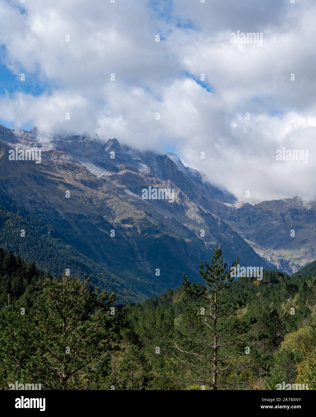 magnificent view of a long glacial forested valley through cloud topped ...