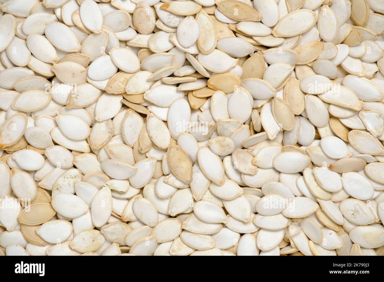 Background, unpeeled pumpkin seeds closeup Stock Photo - Alamy