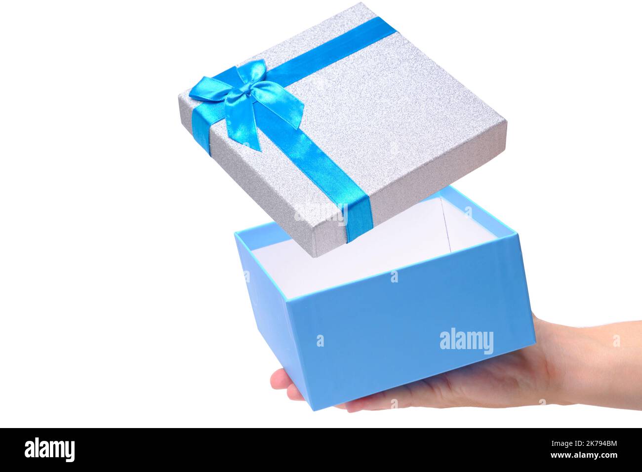 Open blue gift box with bow lying on his arm Stock Photo - Alamy