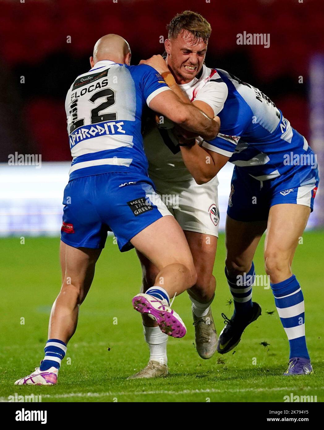 France’s Paul Seguier is tackled by Greece’s Nicholas Flocas (left) and ...