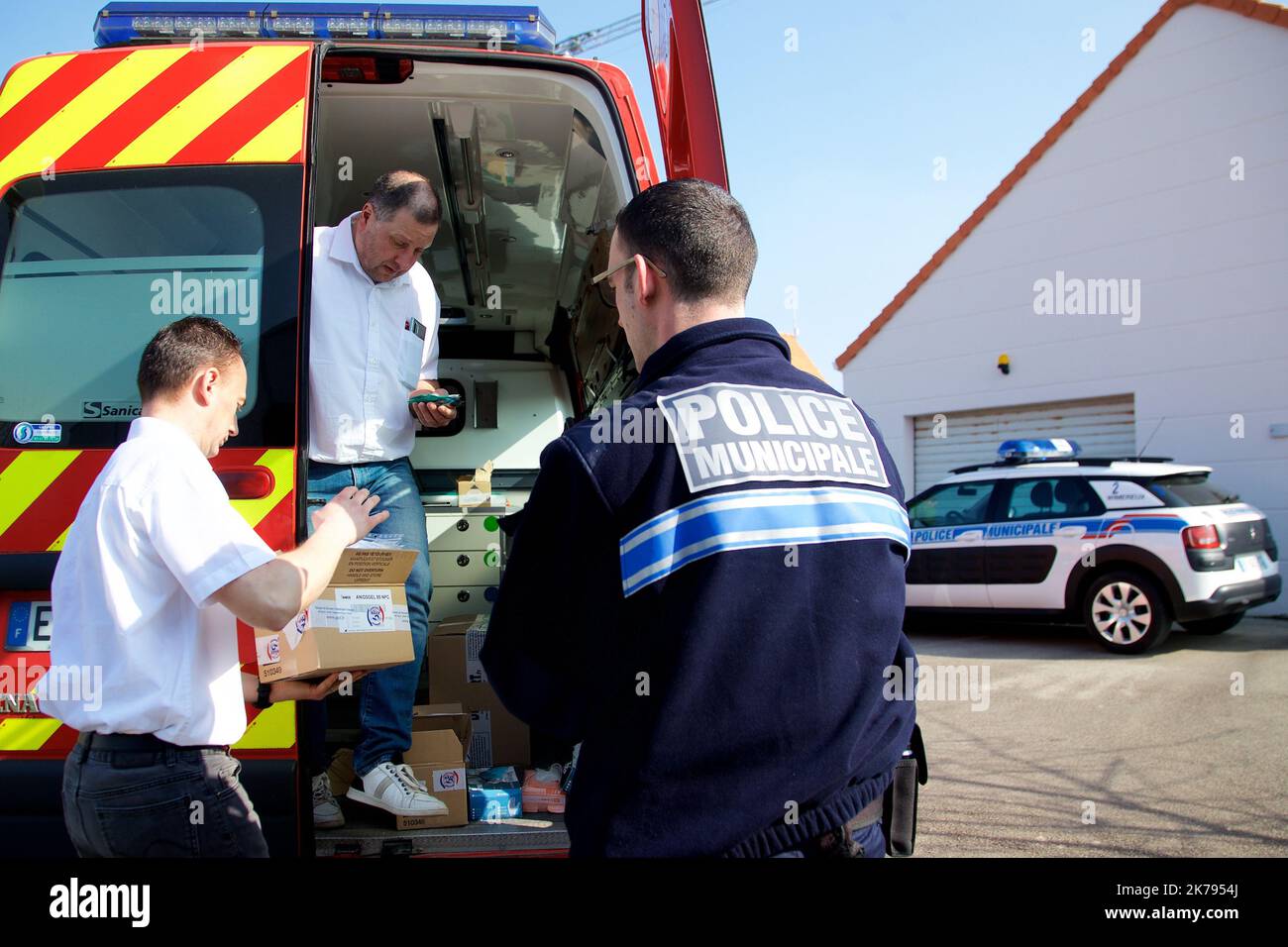 Firefighters of the French disaster relief group donate face masks to ...