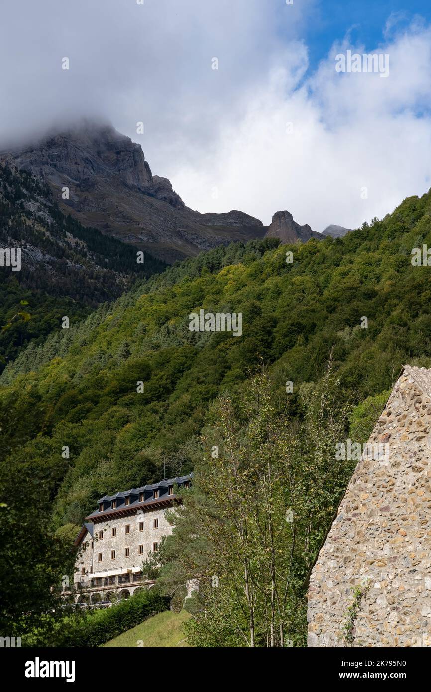 magnificent view of a long glacial forested valley through cloud topped ...