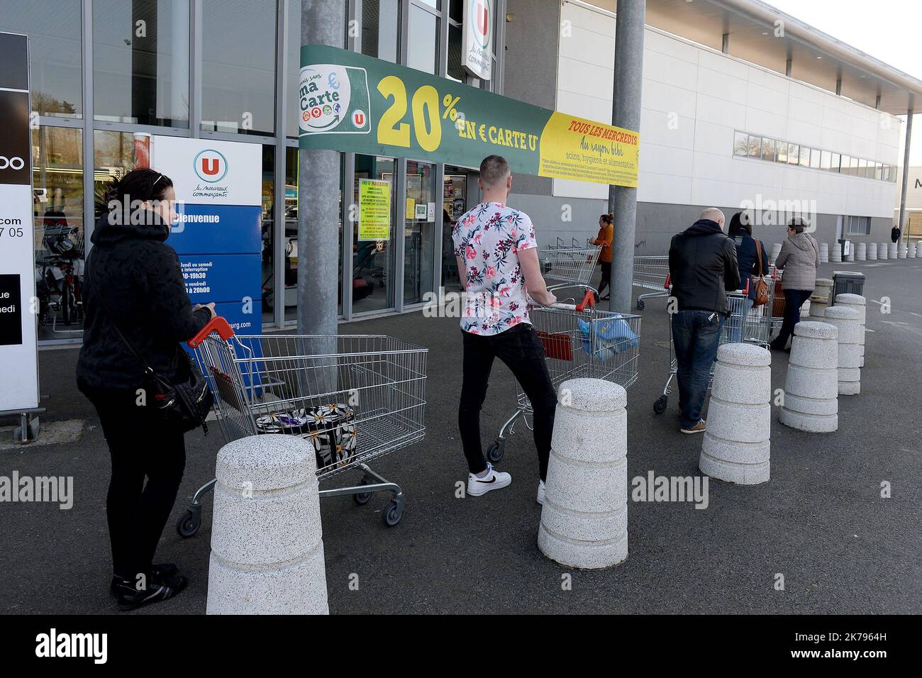 At the Super U store in Chateaubourg, customers wait outside and ...