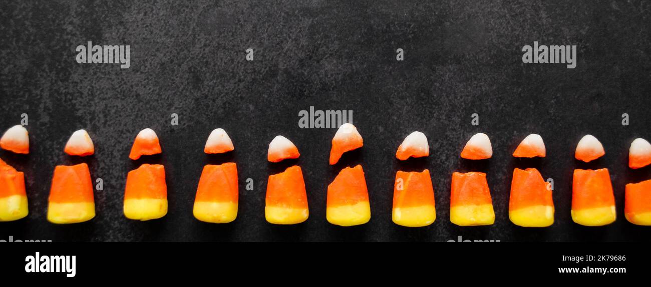 Banner with broken candy corn look like small bad teeth. Black ...