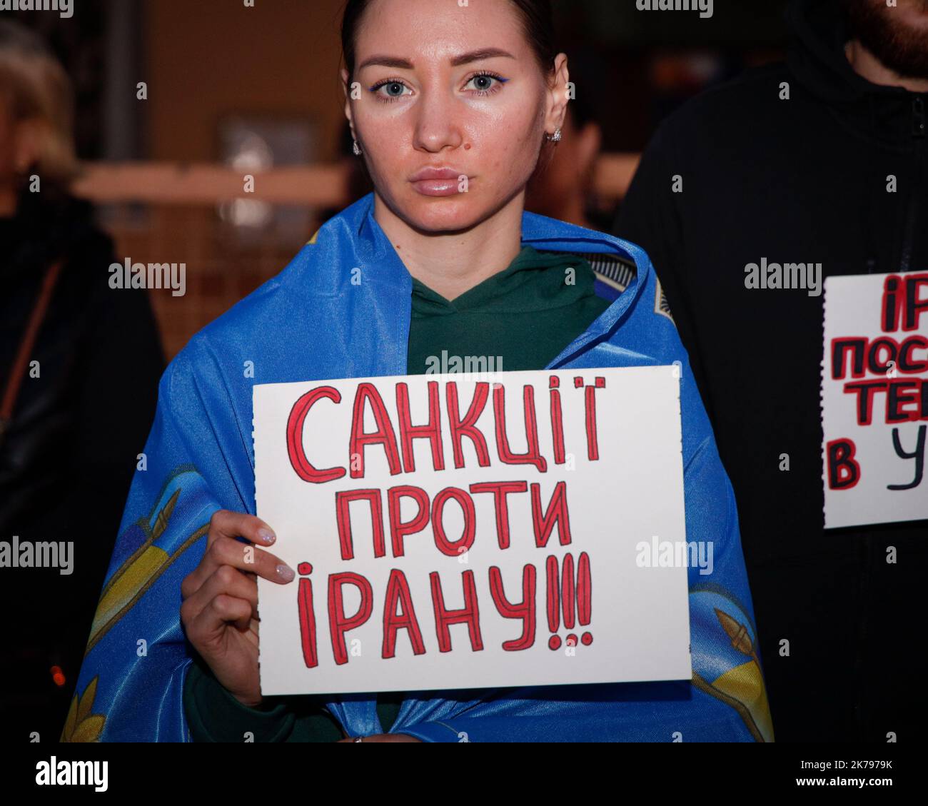 A Woman Holds A Sign In Ukrainian Reading Sanctions Against Iran