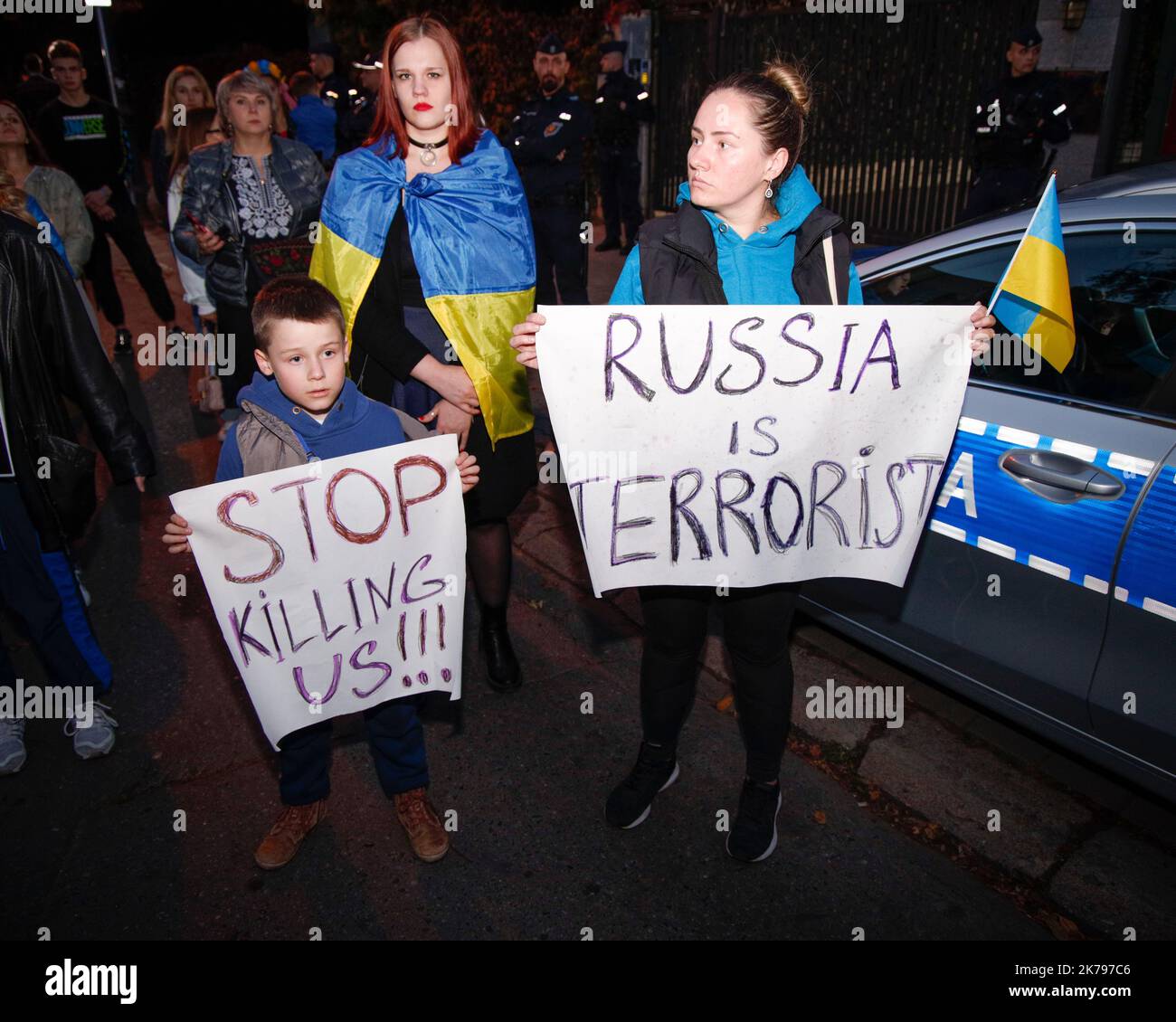 A woman and a child are seen holding signs during a protest in Warsaw ...