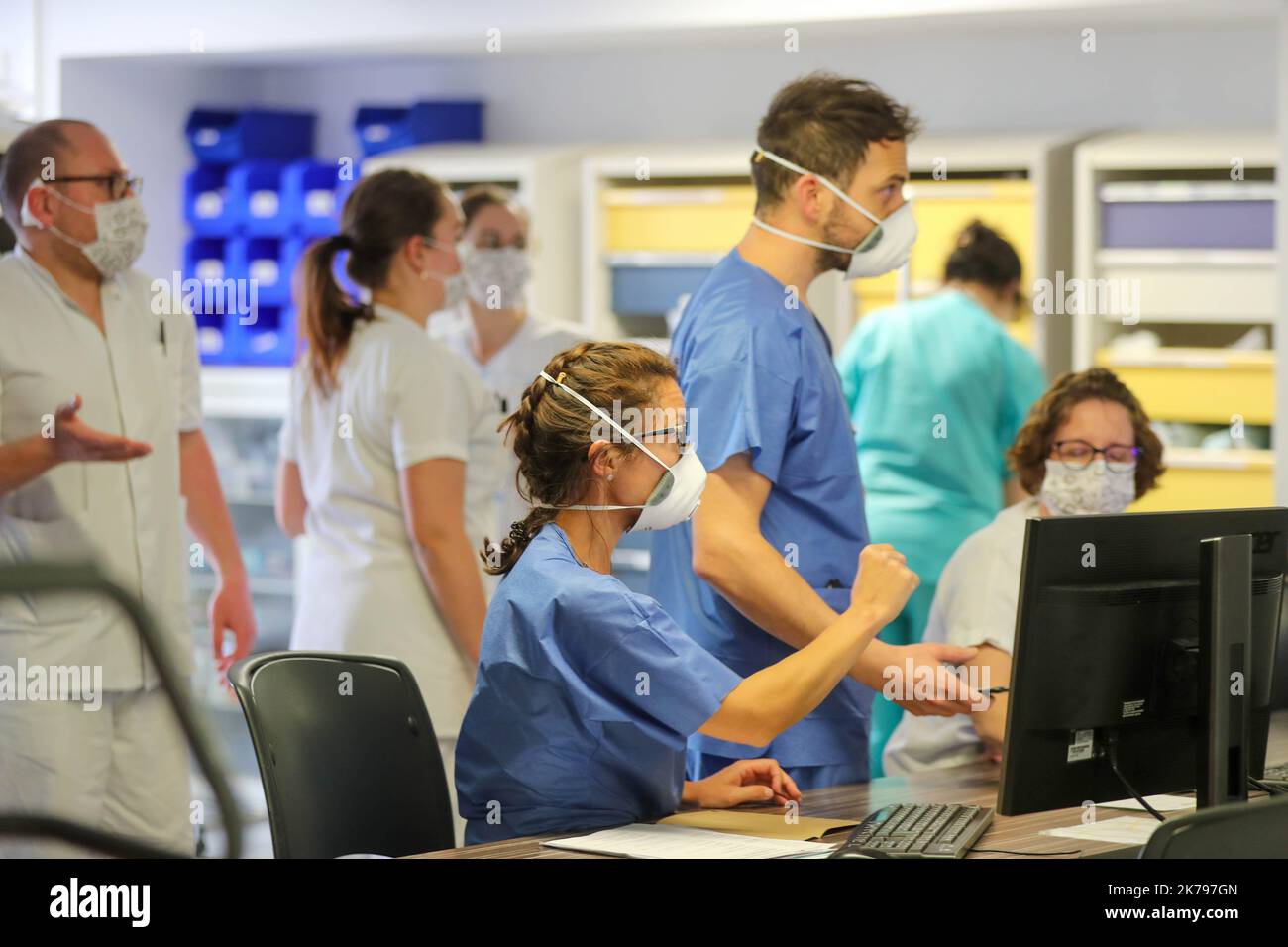 Members of hospital staff wear protective gear whilst working in a ...
