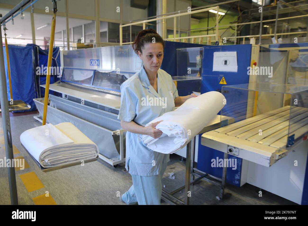 Employees processing linen at the laundry at the Emile Muller hospital ...