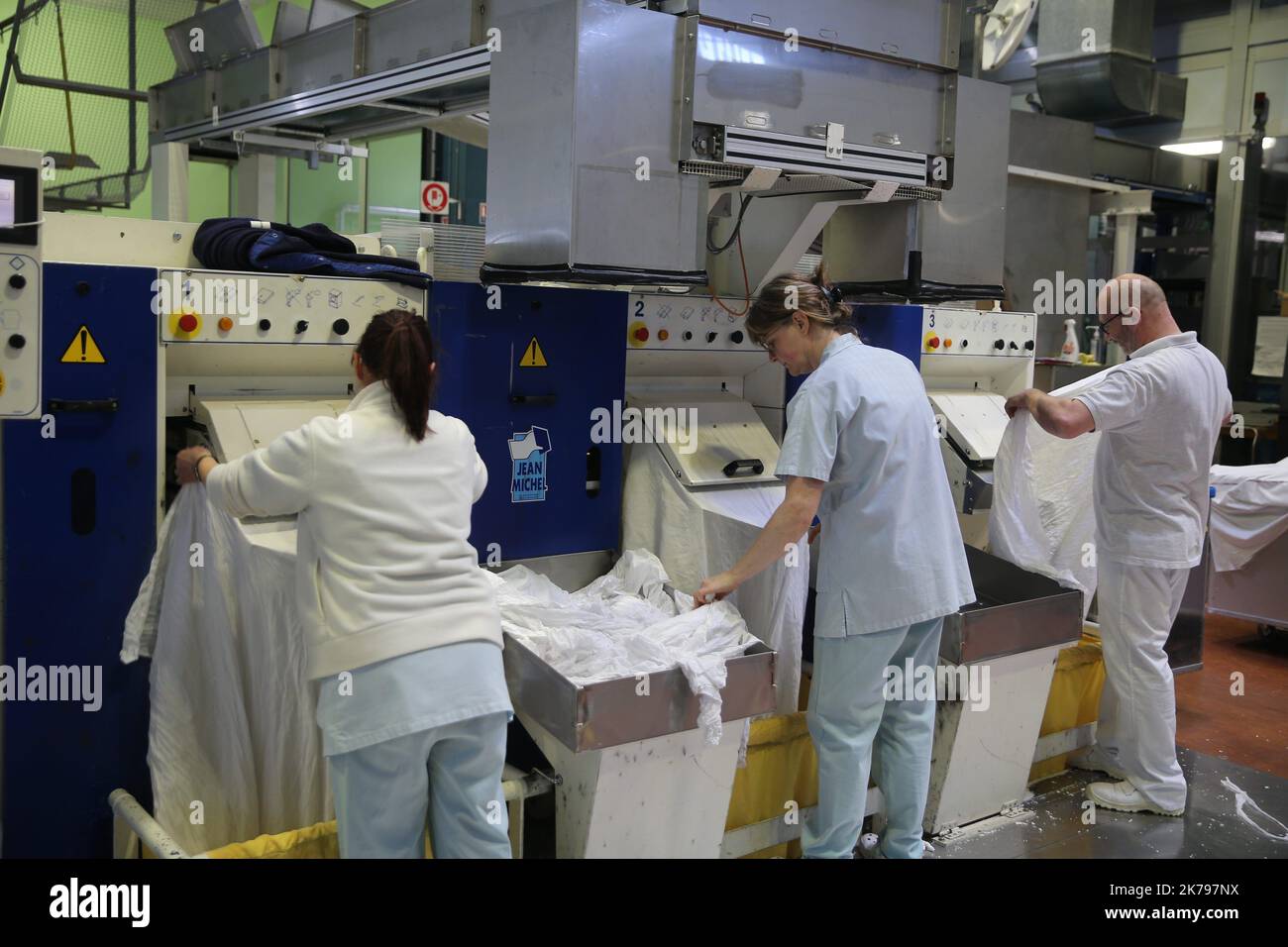 Employees processing linen at the laundry at the Emile Muller hospital in Mulhouse Stock Photo ...
