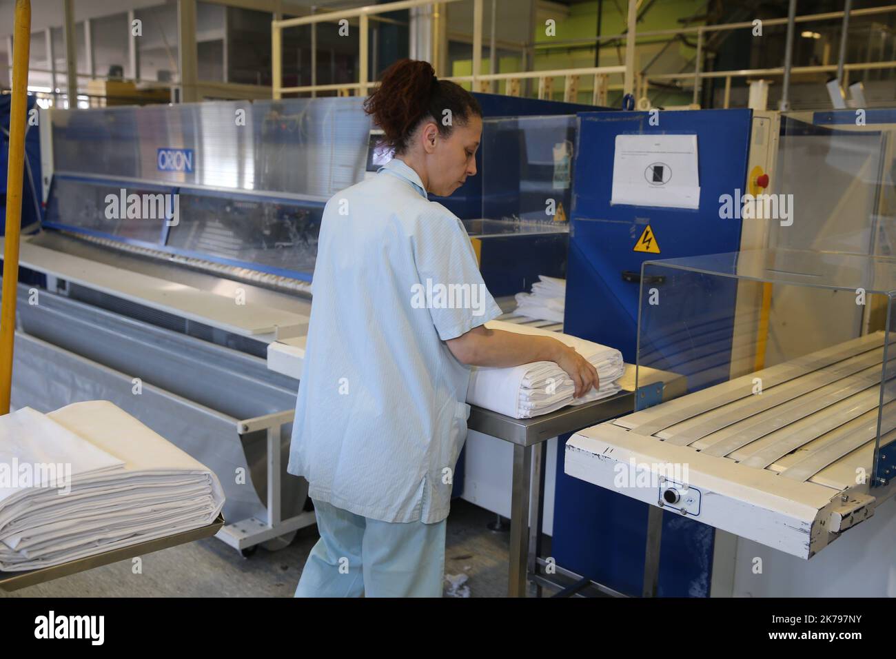 Employees processing linen at the laundry at the Emile Muller hospital in Mulhouse Stock Photo ...
