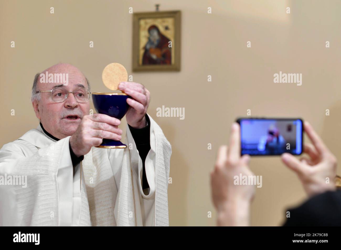 A lit Paschal candle and Christ on his Cross, and candles in the ...
