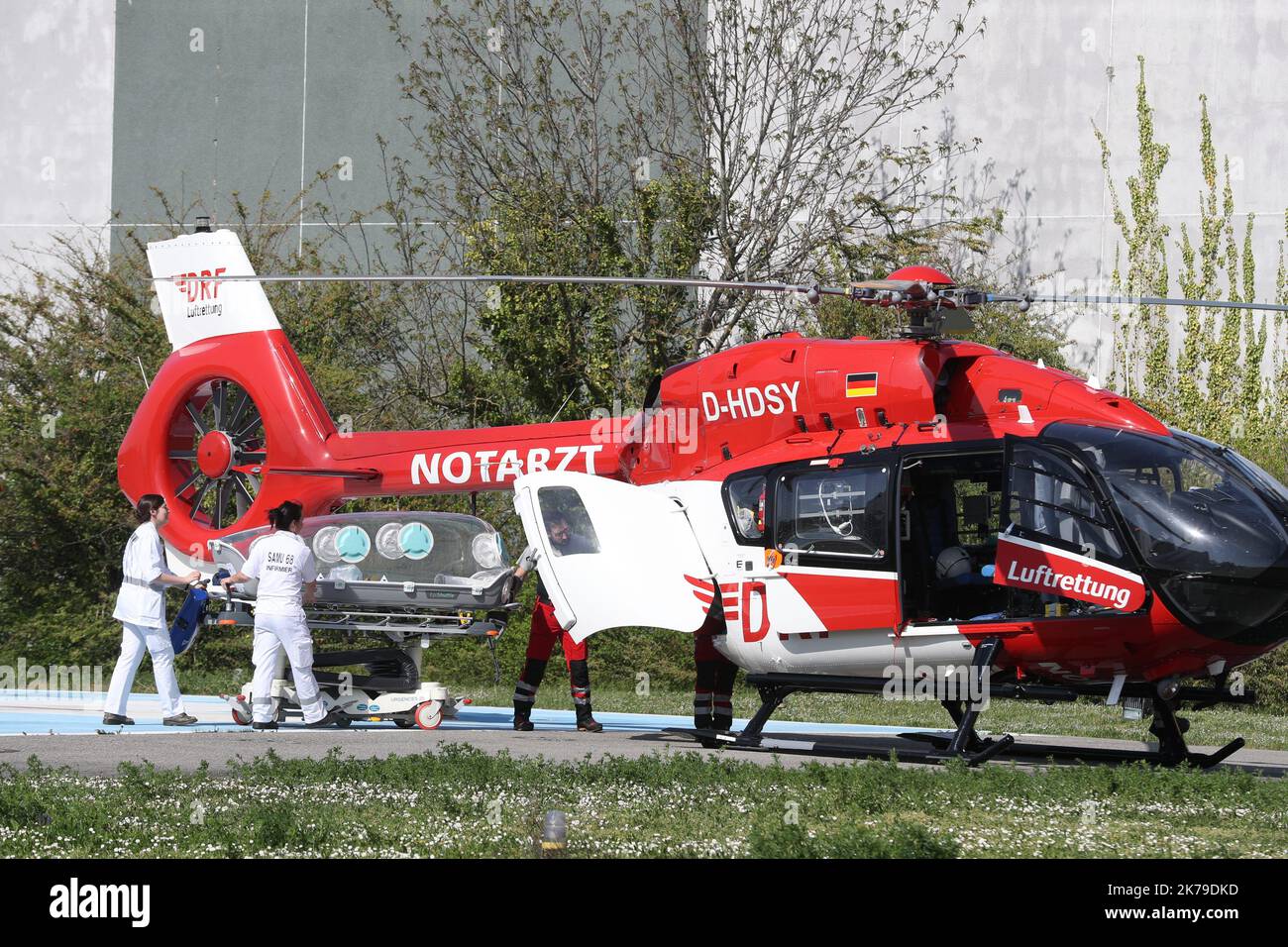 A German helicopter prepares to take off after dropping a patient with ...