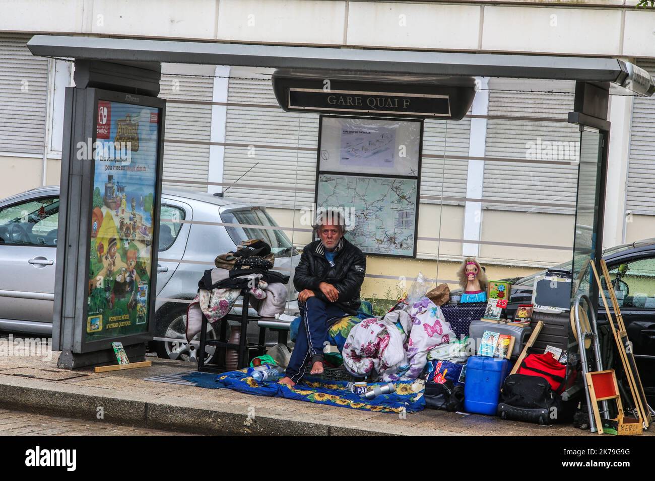 A homeless man living in a bus shelter in Thionville, France Stock ...