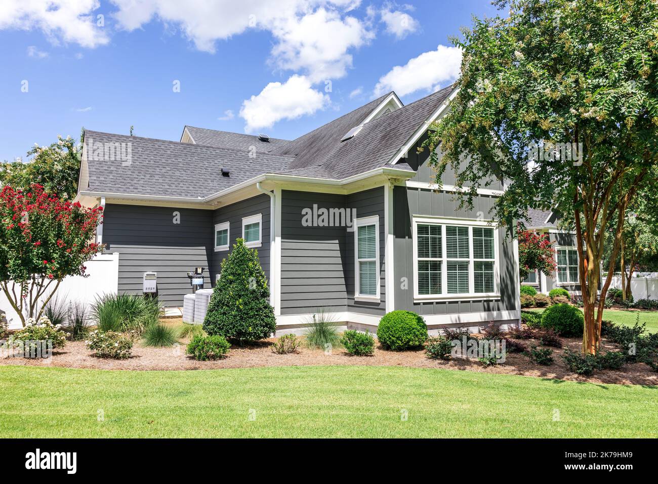 Side view of a large gray craftsman new construction house with a ...