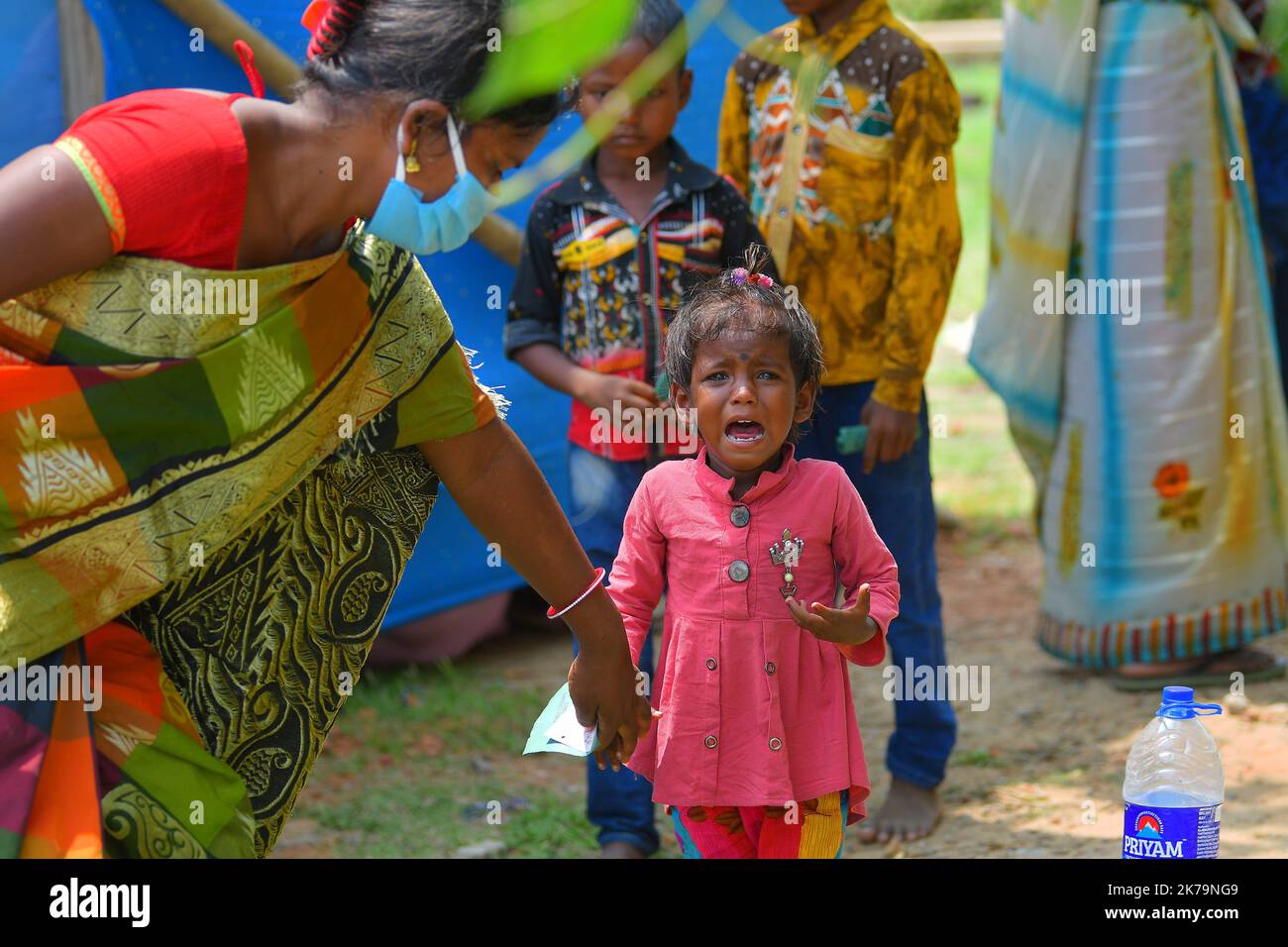 India / Tripura / Agartala - Migrant workers and family members line up to show their papers and ...
