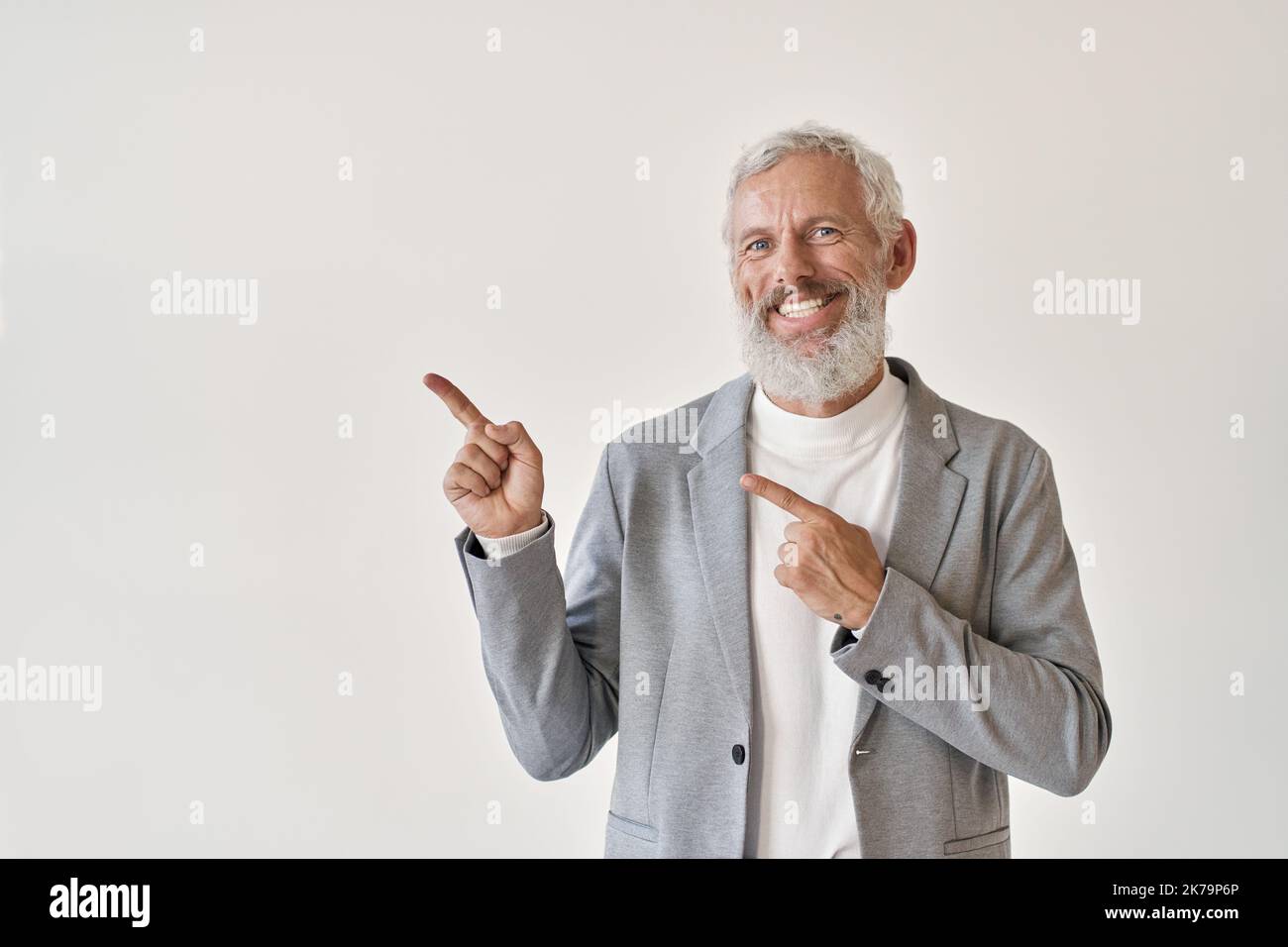 Happy old senior business man pointing fingers aside isolated on white ...