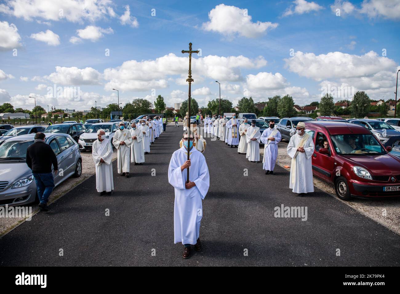 Priests and officiants arrive in procession in the midst of the ...