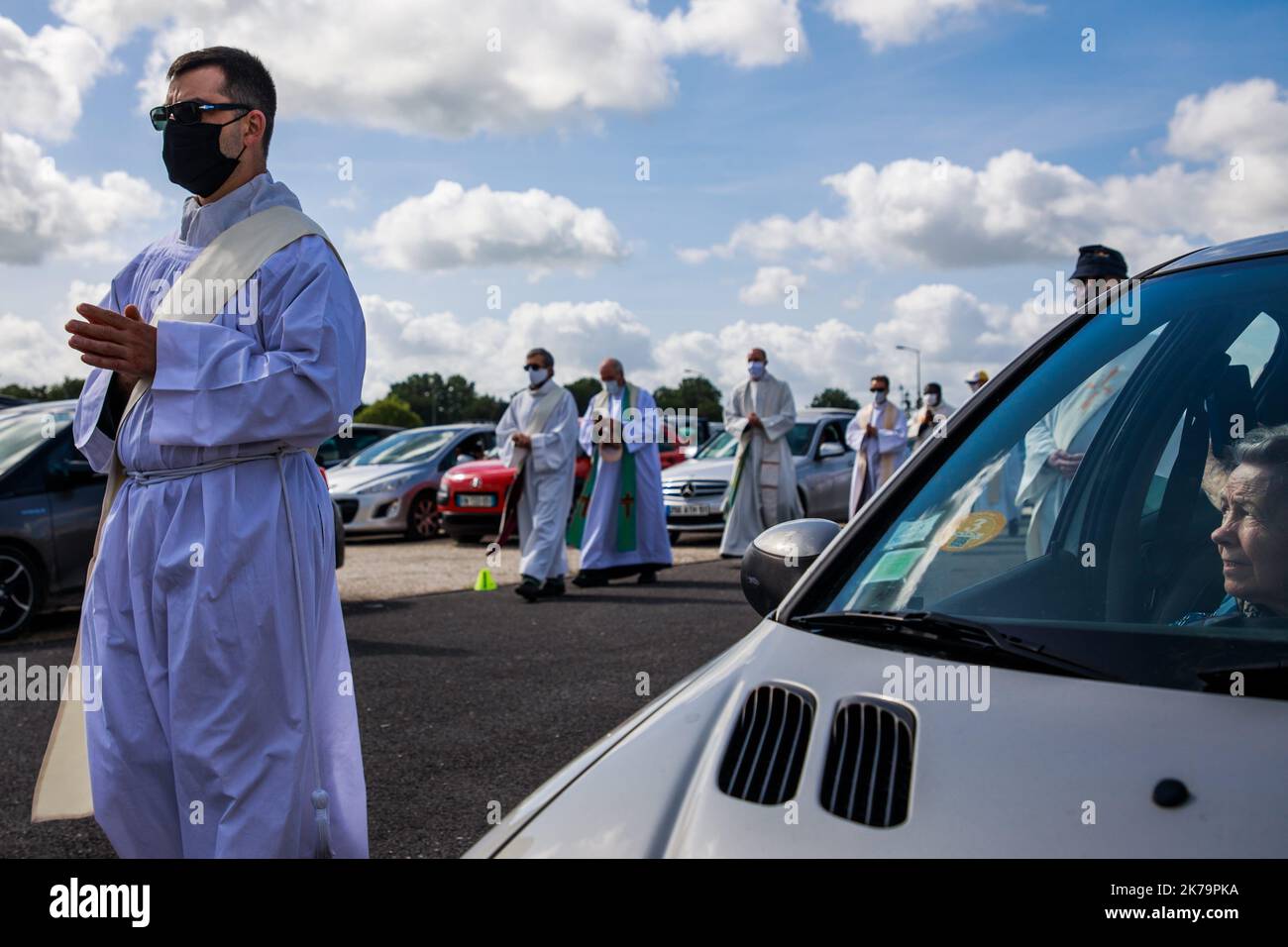 Priests and officiants arrive in procession in the midst of the ...