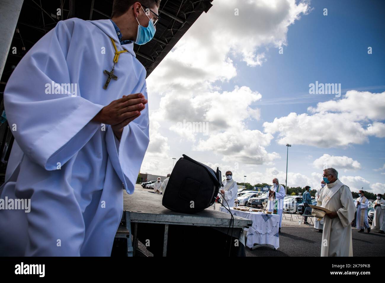 Priests and officiants arrive in procession in the midst of the ...