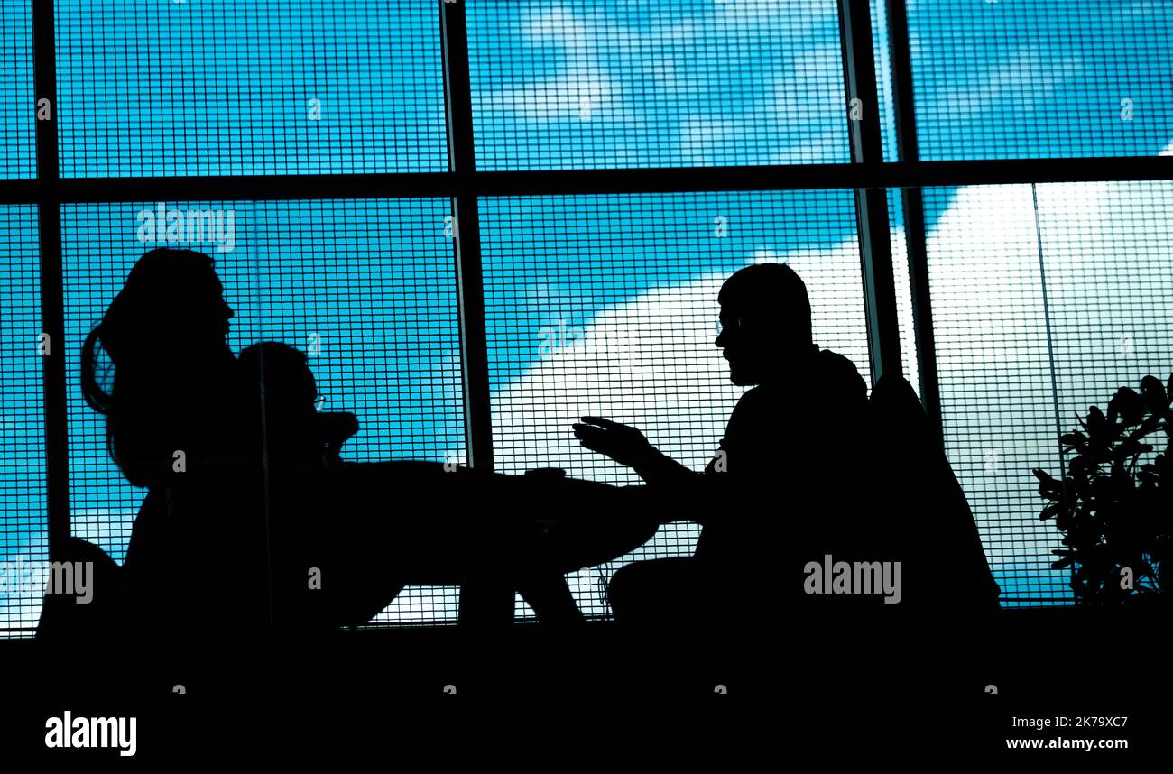 Anonymous family speaking in cafe Stock Photo - Alamy