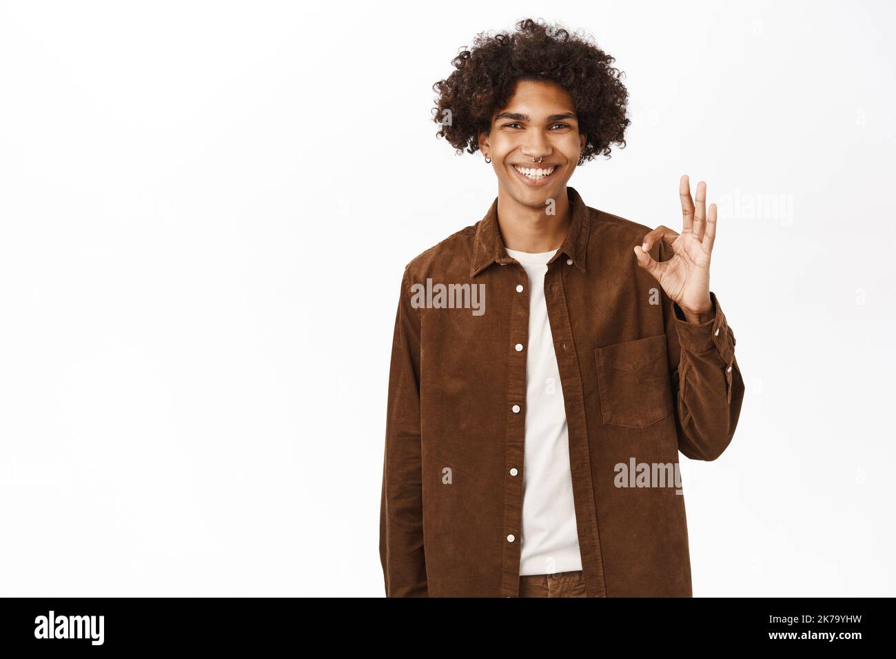 Portrait of smiling hispanic guy shows okay, ok approval sign, agree ...