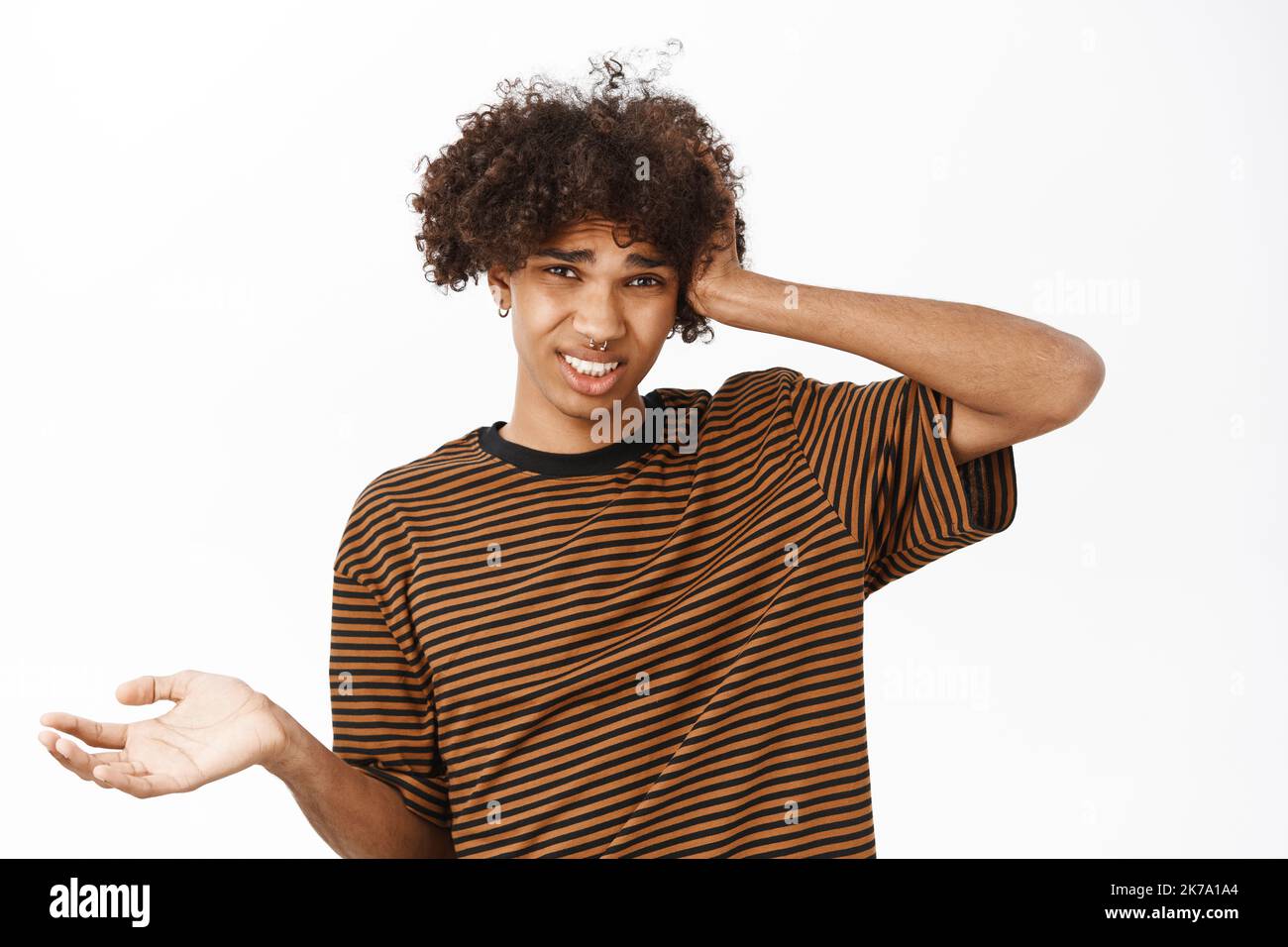 Portrait of confused guy scratching his head ad looking clueless ...