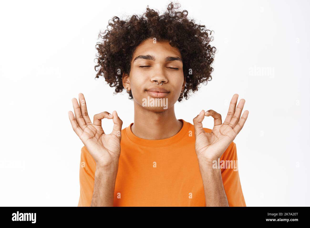 Mindfulness and meditation. Young man meditating, feeling zen and ...
