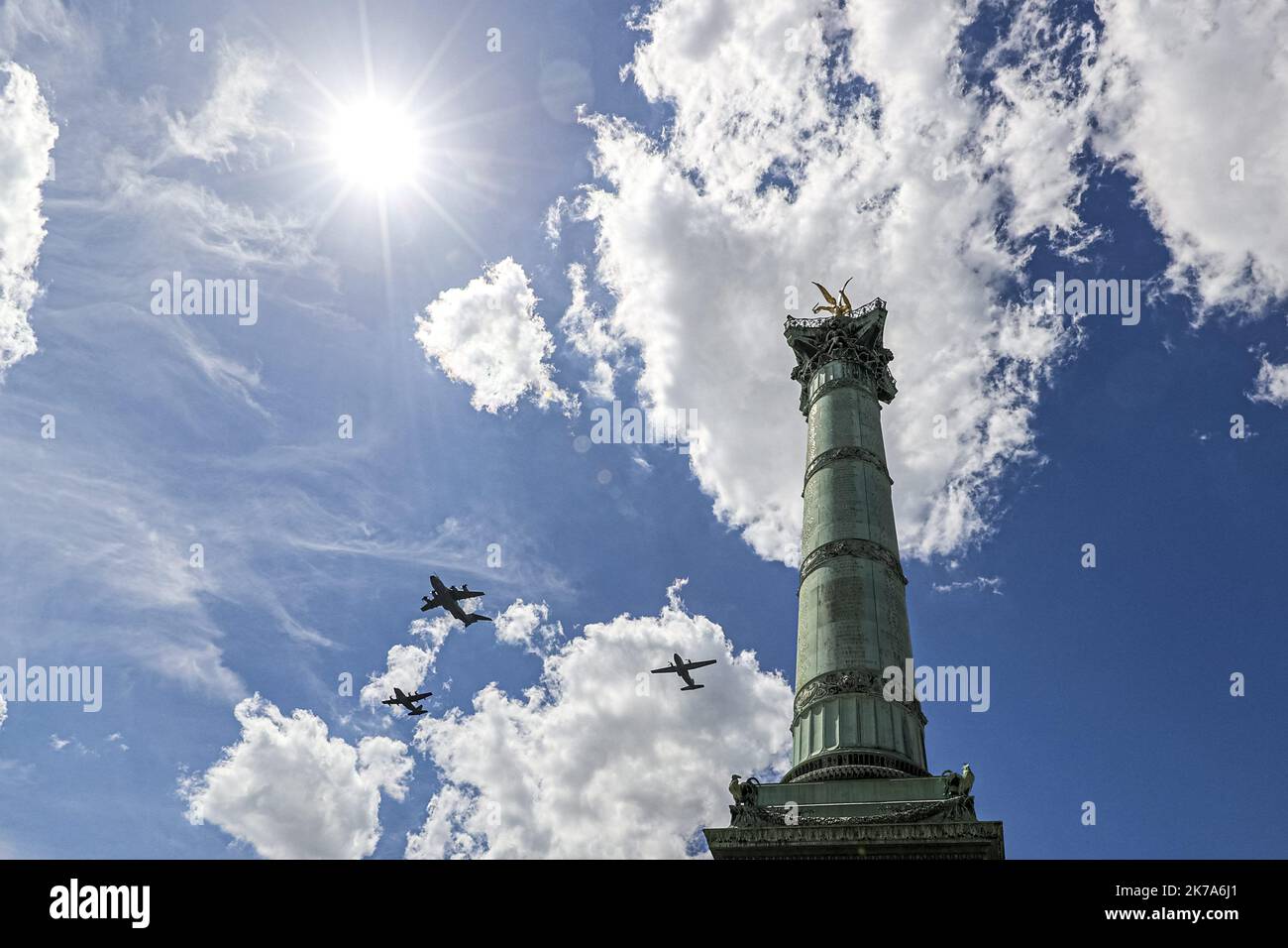 French military aircraft flies over the July Column monument on Place ...