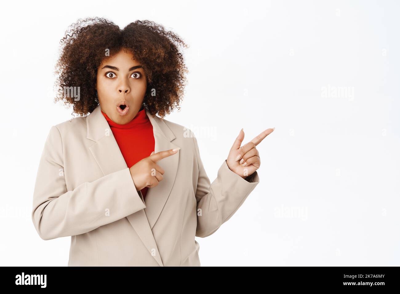 Surprised african american businesswoman, looks amazed, say wow and ...