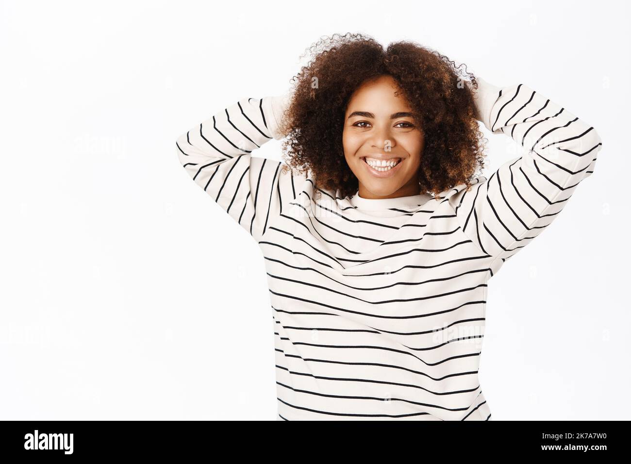 Carefree young african american woman in casual shirt, looking happy ...