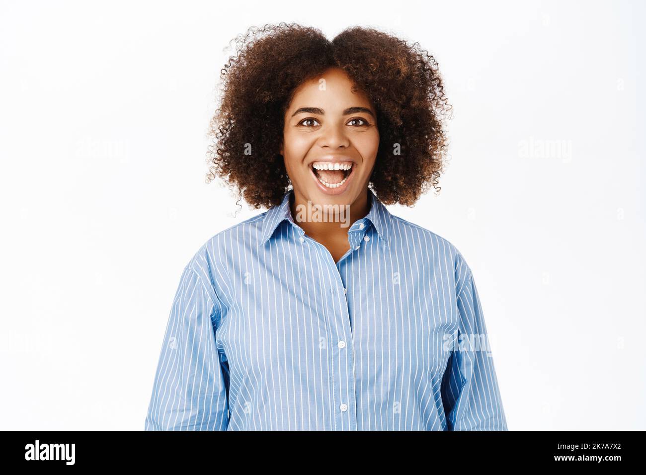 Excited african american young woman, looking amazed and fascinated ...