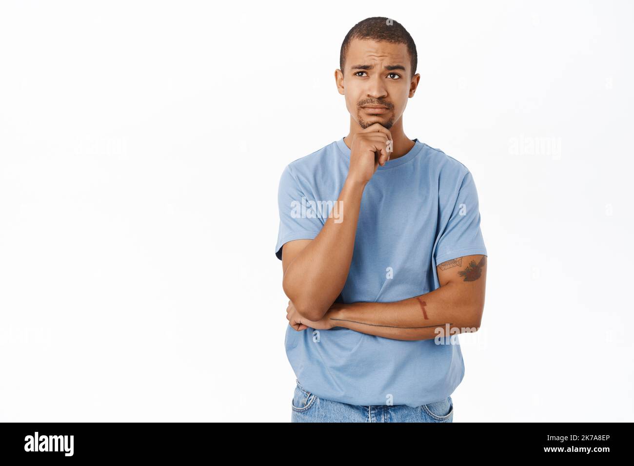 Portrait of man thinking, looking complicated or puzzled while ...