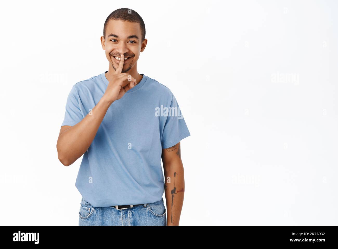 Portrait of guy shushing, showing taboo quiet gesture, press finger to ...