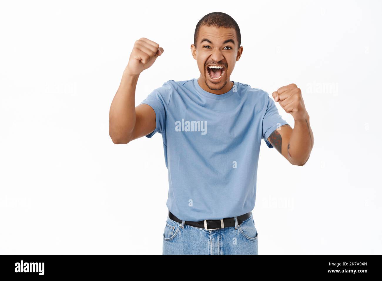 Enthusiastic arab guy shouting, cheering, watching sports game and ...