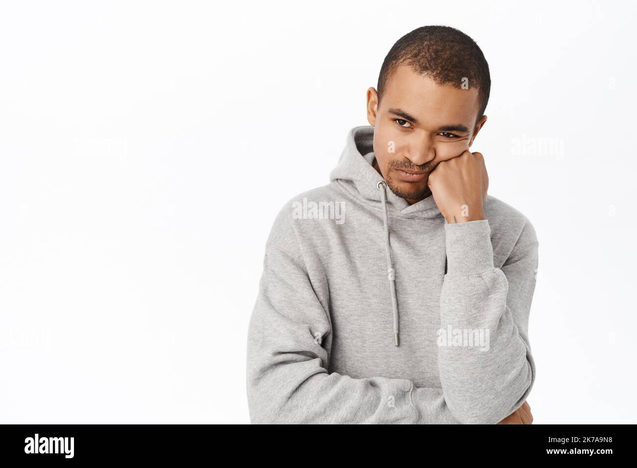 Bored or uspet young man, lean head on arm and looking disappointed ...