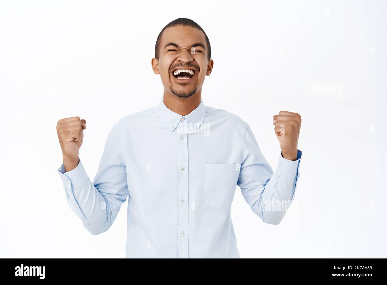 Celebrating success. Excited young man scream of joy, winning and ...