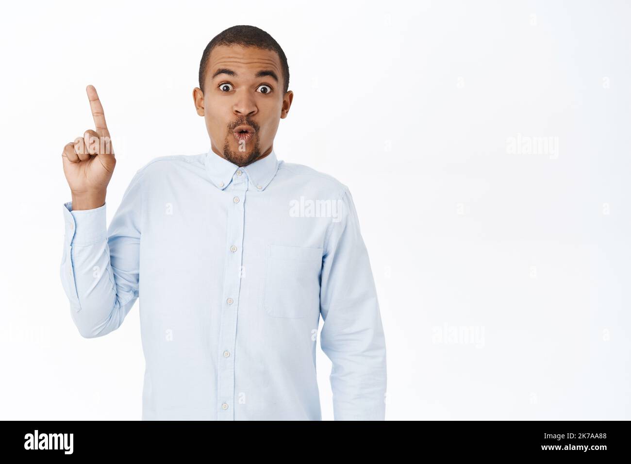 Surprised businessman pointing finger up and say wow with impressed ...