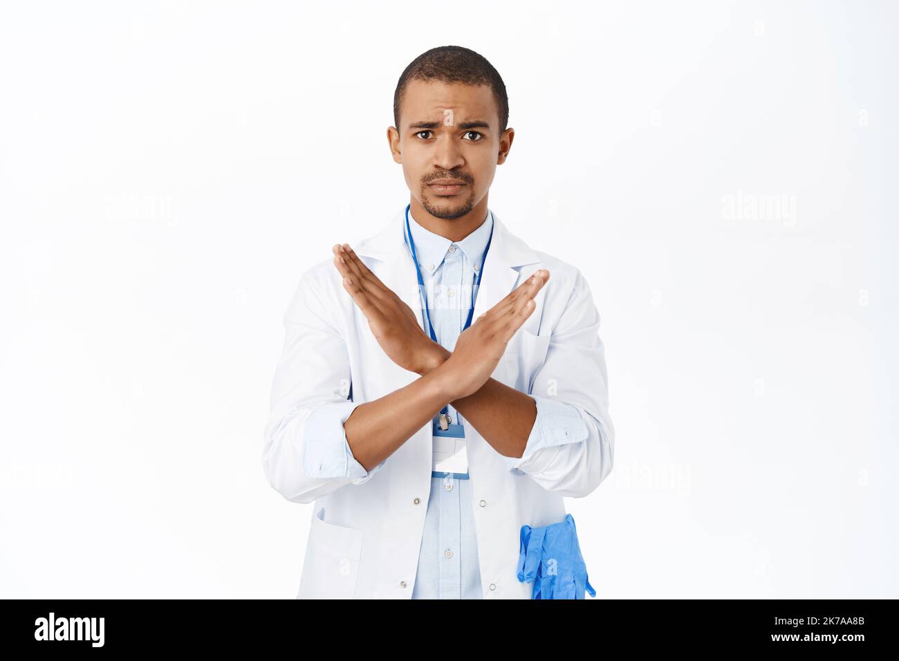 Serious doctor shows cross, stop gesture, disapprove smth, prohibit ...