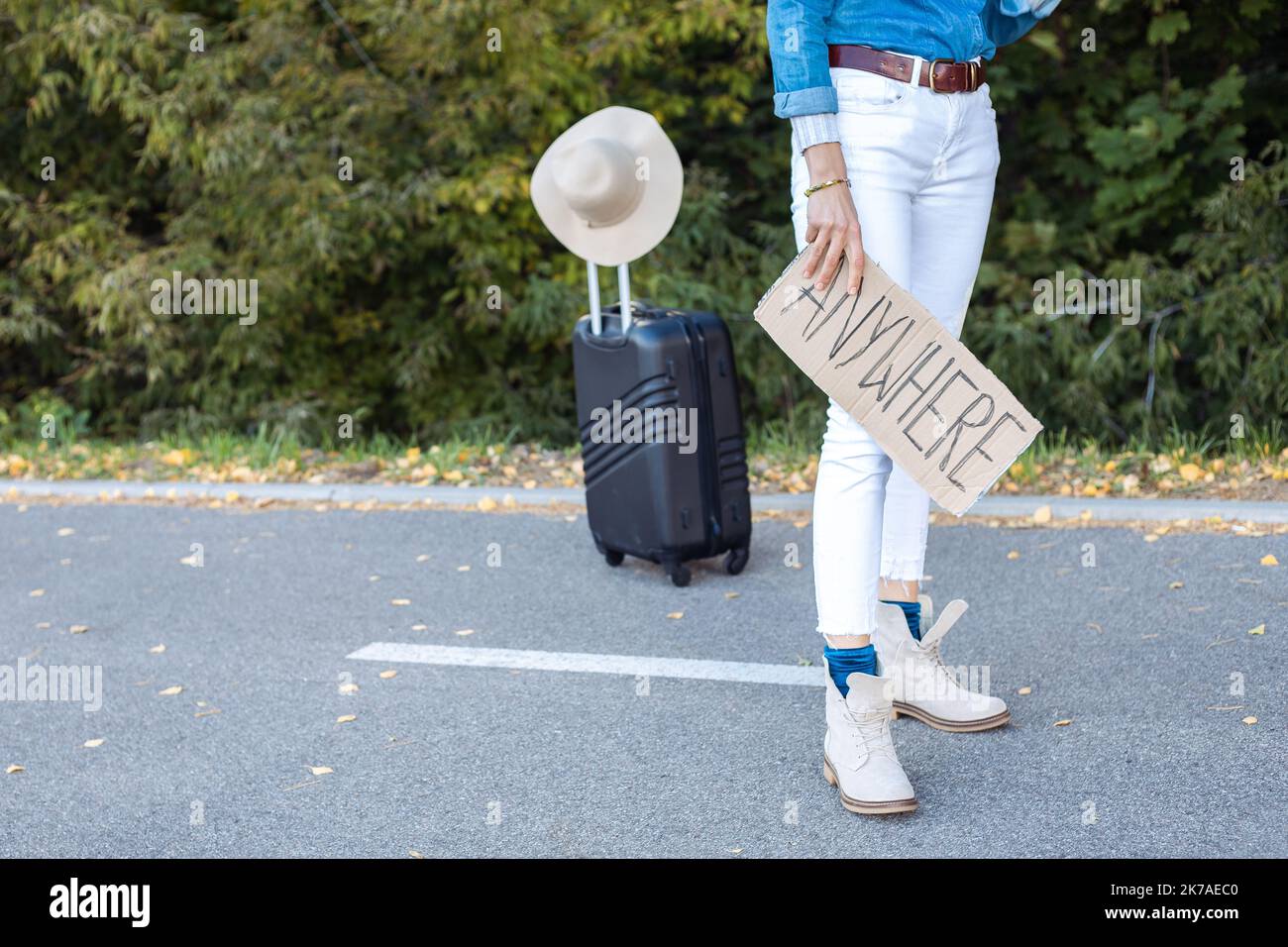 Photo of lower body of woman wait passing car in forest standing with ...