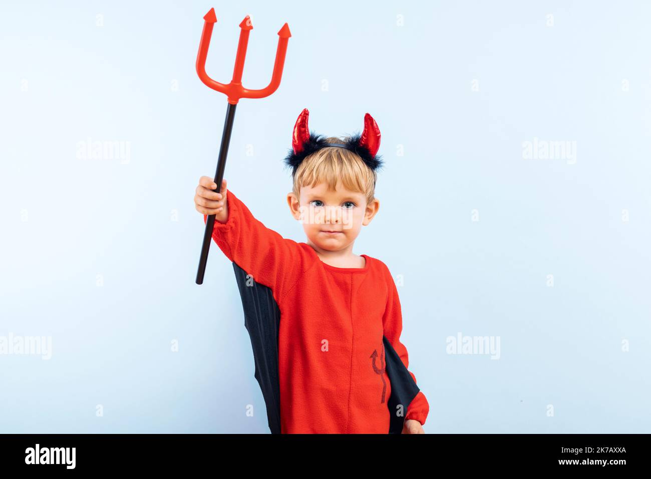 Cute little boy in devil halloween costume with horns and trident Stock ...