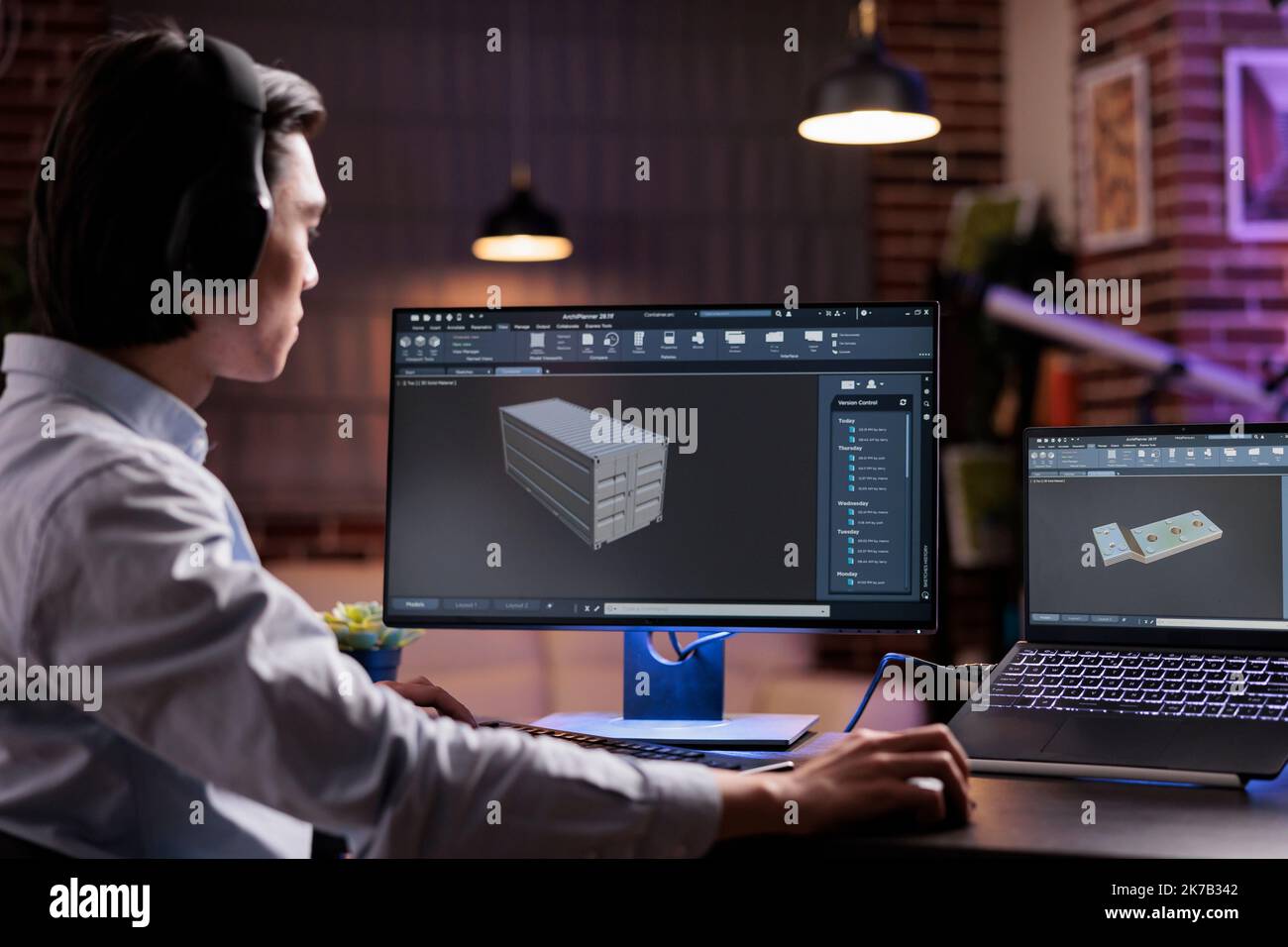 Male engineer working on industrial manufacture of technical engine product with infographics ...