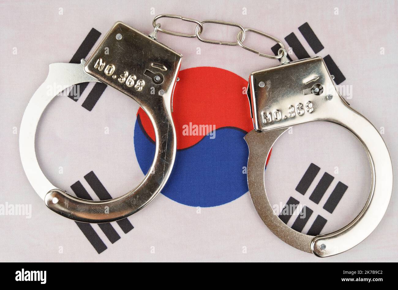 The concept of law and crime. There are handcuffs on the flag of South ...
