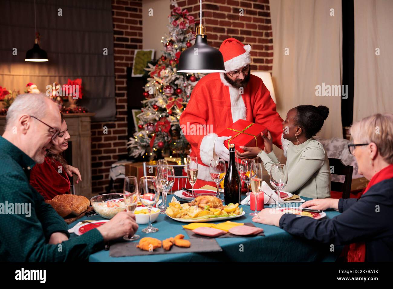 Family exchanging christmas presents, african american woman getting ...