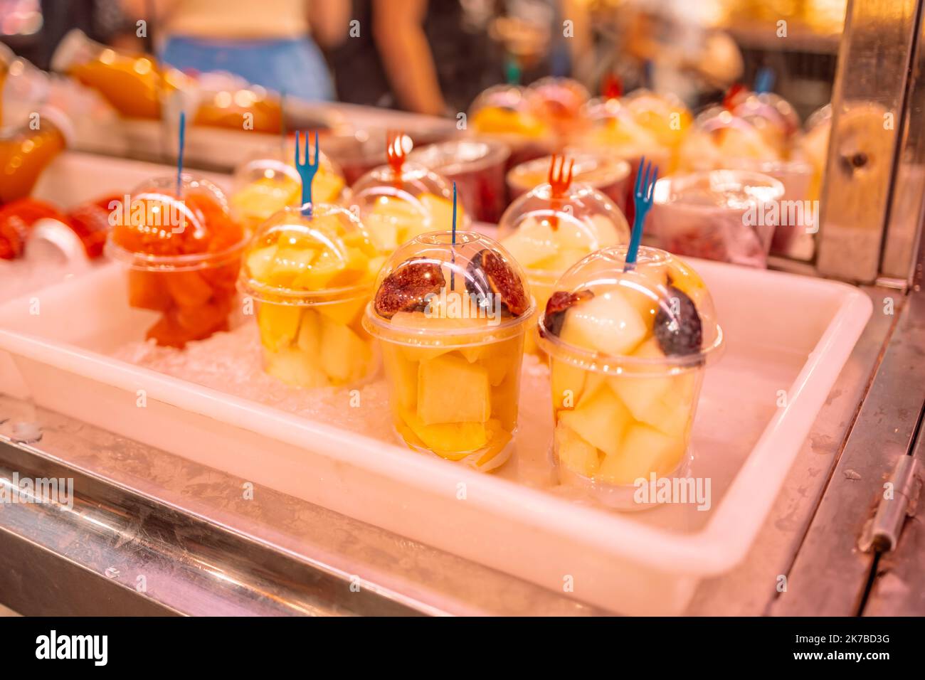 Fresh fruit slicing in a cup. Exhibition of a plastic box with fresh ...
