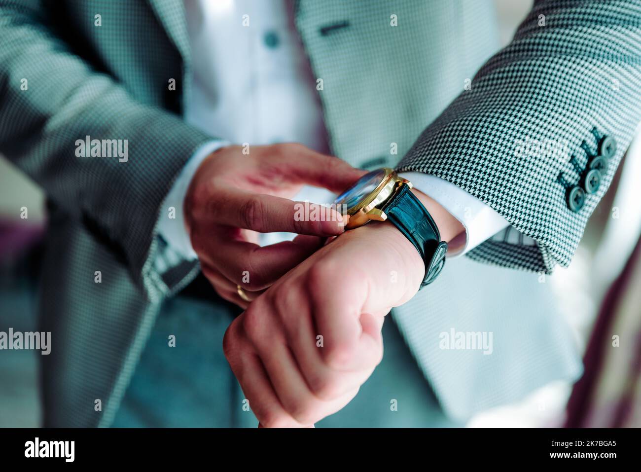 businessman checking time on his wrist watch, man putting clock on hand ...